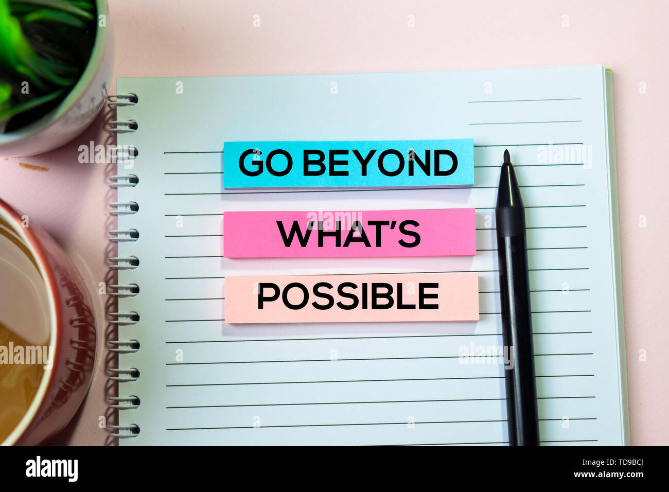Go Beyond What's Possible text on sticky notes with office desk concept ...