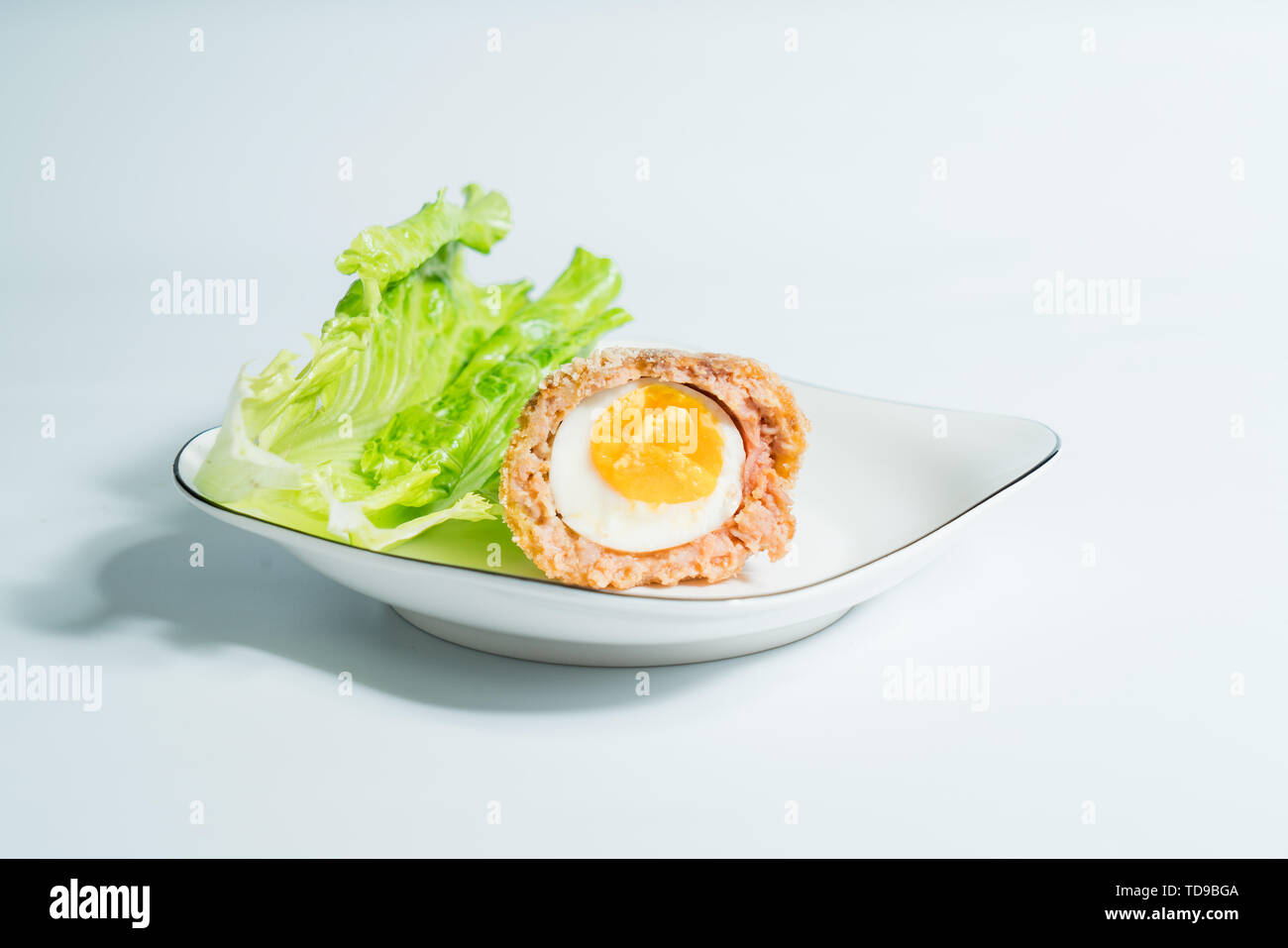 Scottish egg pendulum plate with white background Stock Photo - Alamy