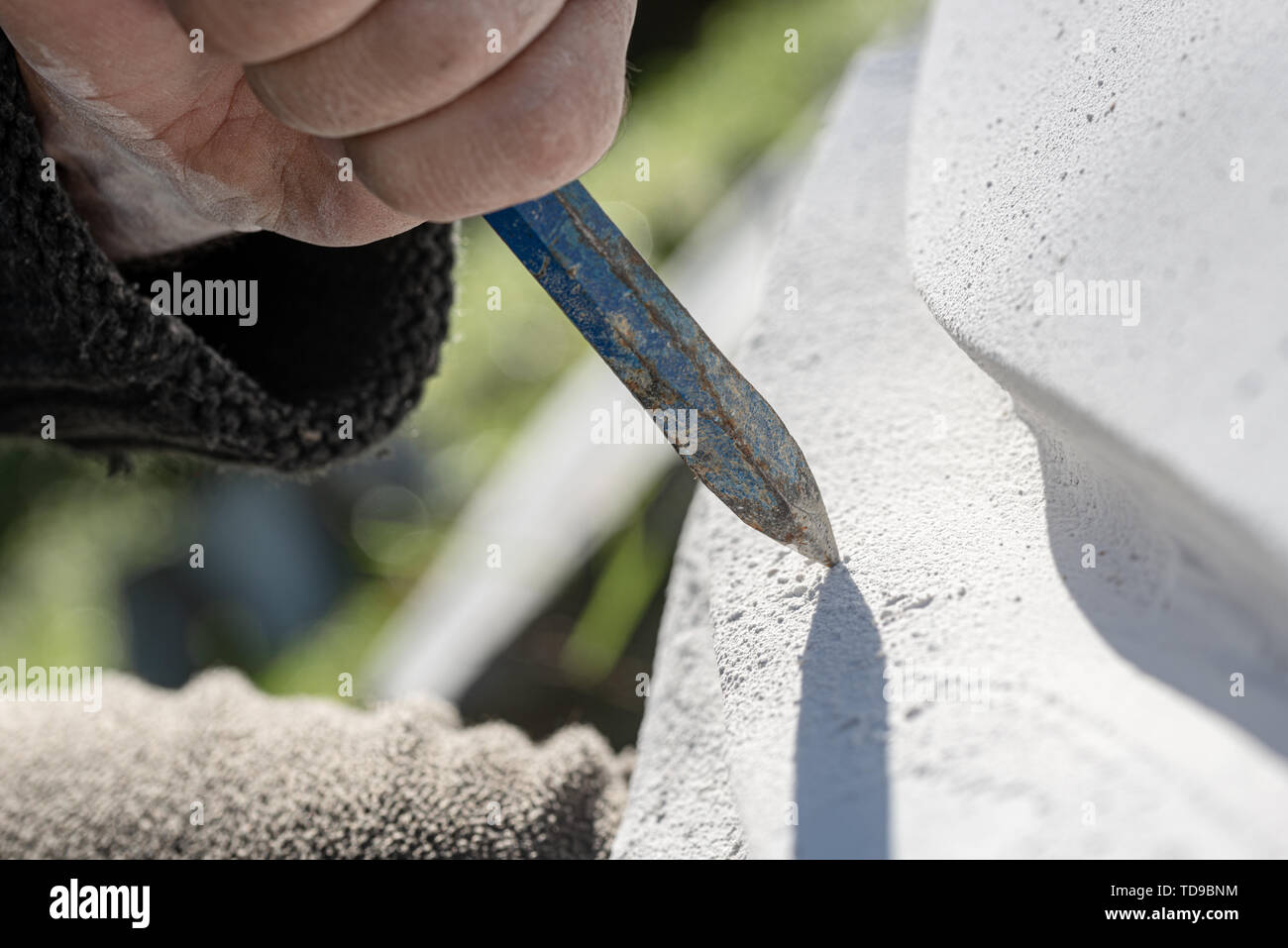 Closeup view of chisel as sculptor works and carves in stone Stock ...