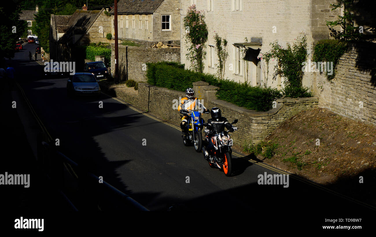 Man riding a motorcycle in an English village Stock Photo - Alamy