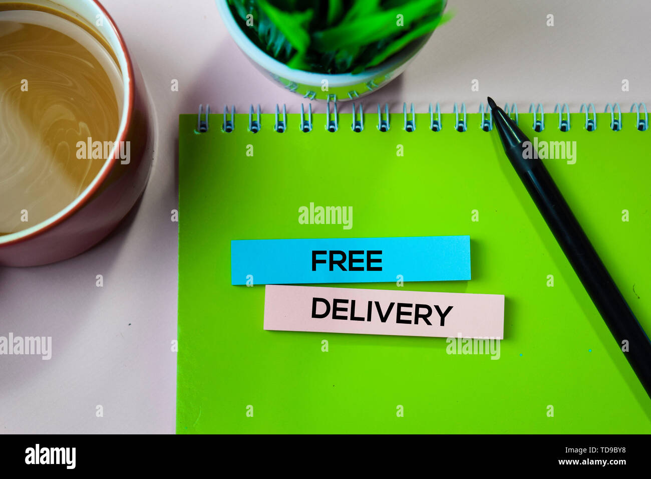 Free Delivery text on sticky notes with office desk concept Stock Photo ...
