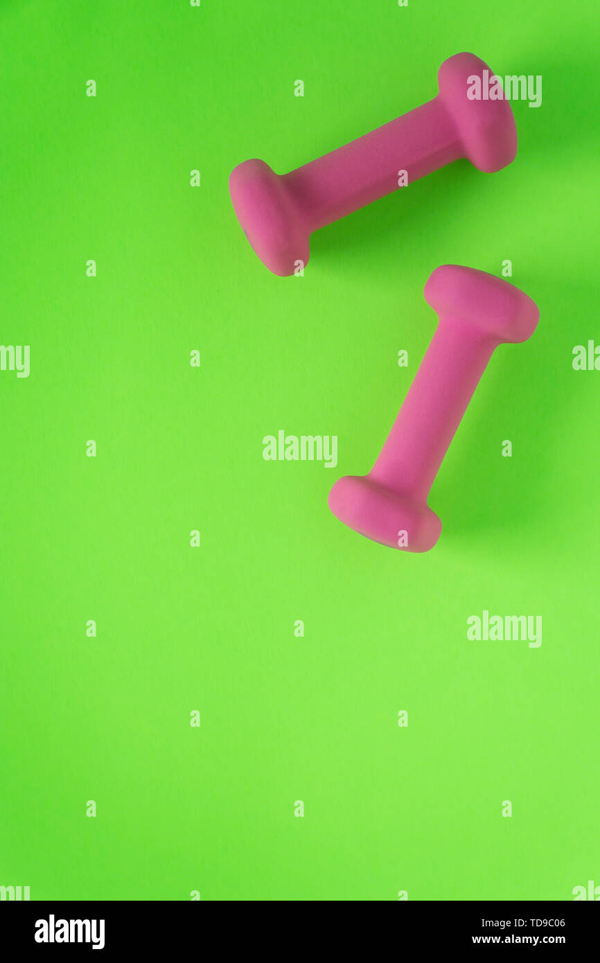 Fitness equipment with womens pink weights/ dumbbells isolated on a ...