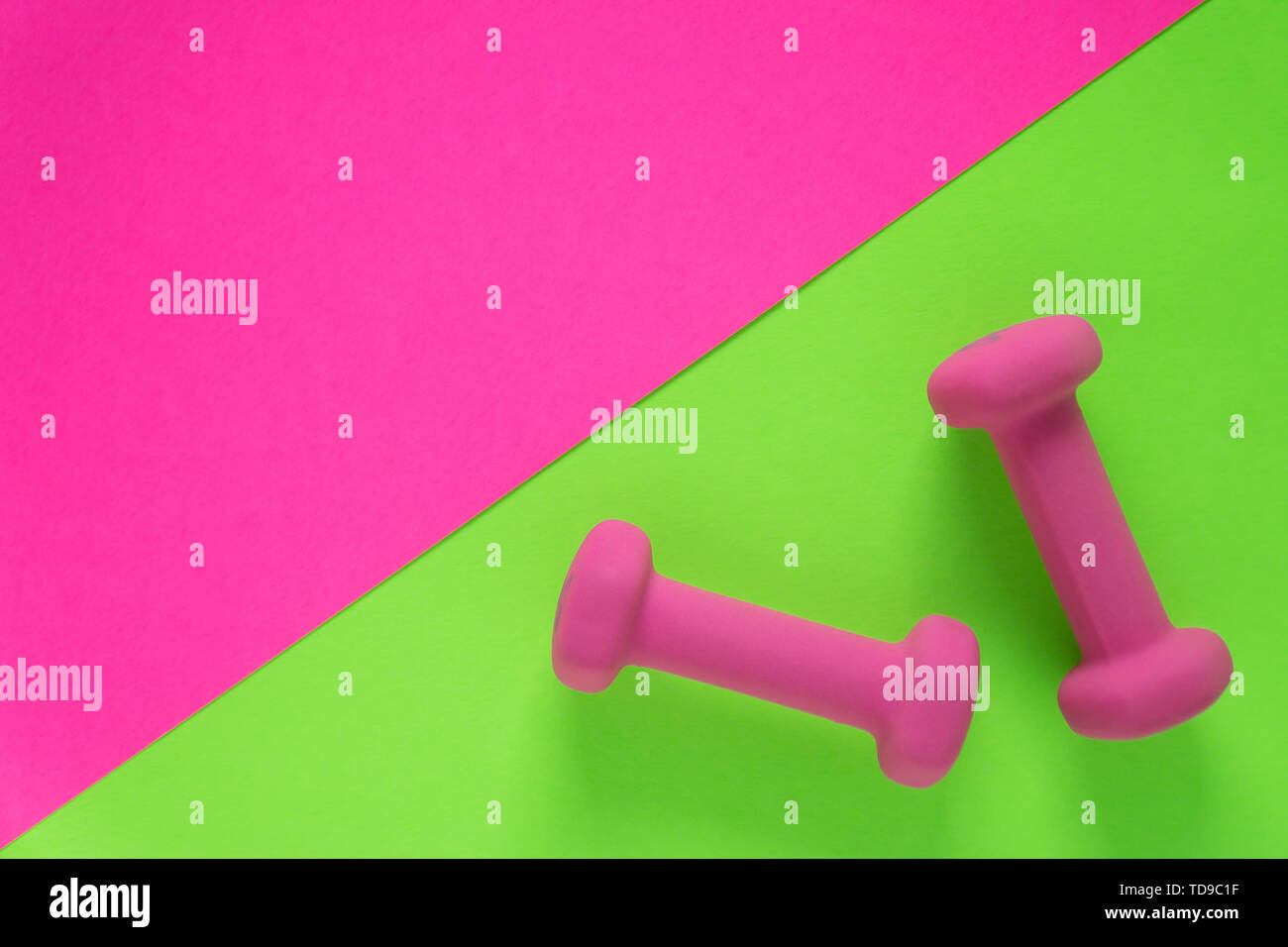 Fitness equipment with womens pink weights/ dumbbells isolated on a ...