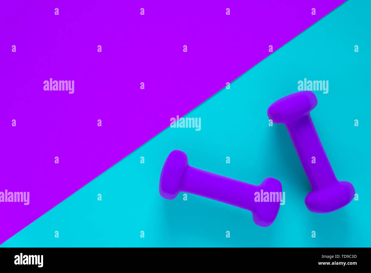 Fitness equipment with womens purple weights/ dumbbells isolated on a ...