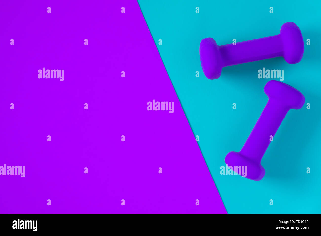 Fitness equipment with womens purple weights/ dumbbells isolated on a ...