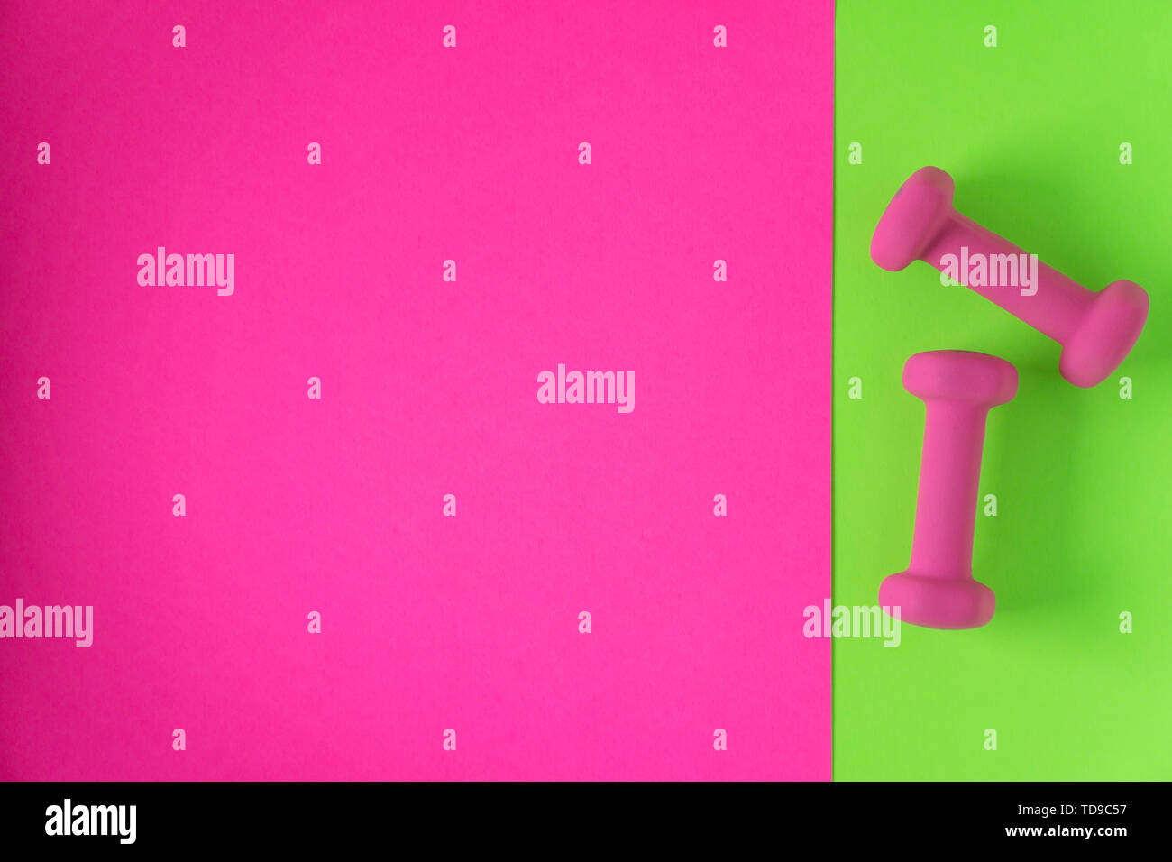 Fitness equipment with womens pink weights/ dumbbells isolated on a ...