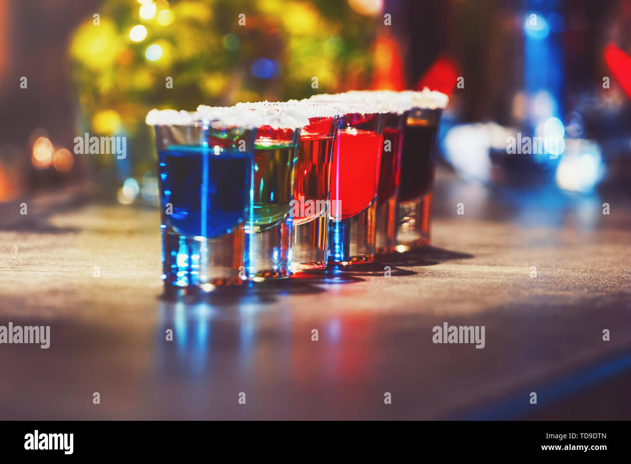Alcoholic cocktail row on bar counter, colorful shooters cocktails ...