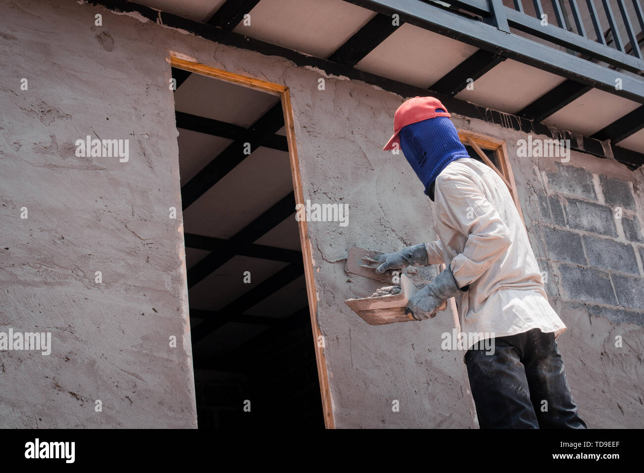 Construction workers plastering building wall using cement plaster ...
