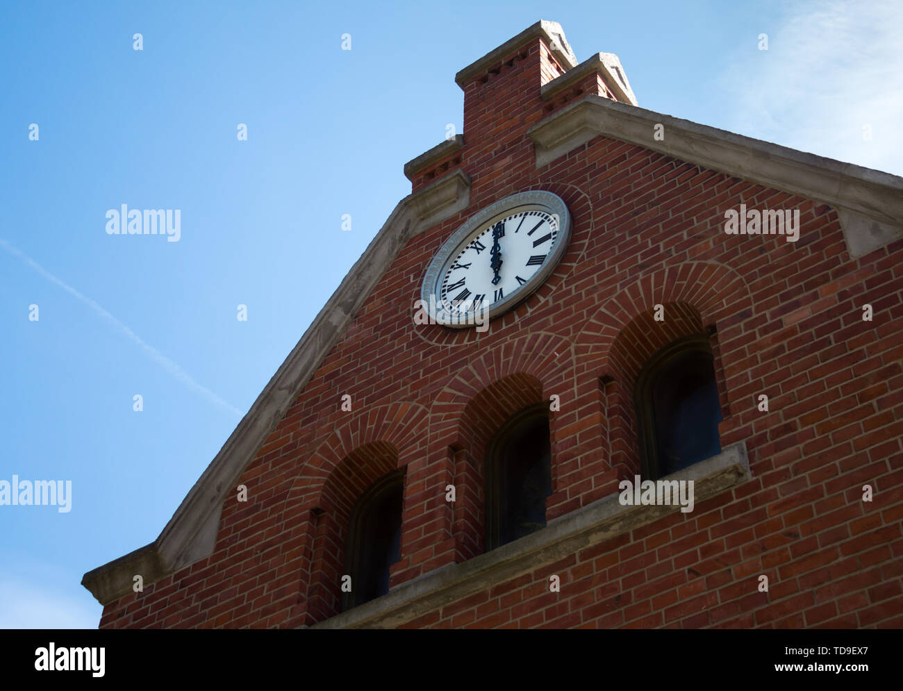 Old historical brick building with an antique clock Stock Photo - Alamy