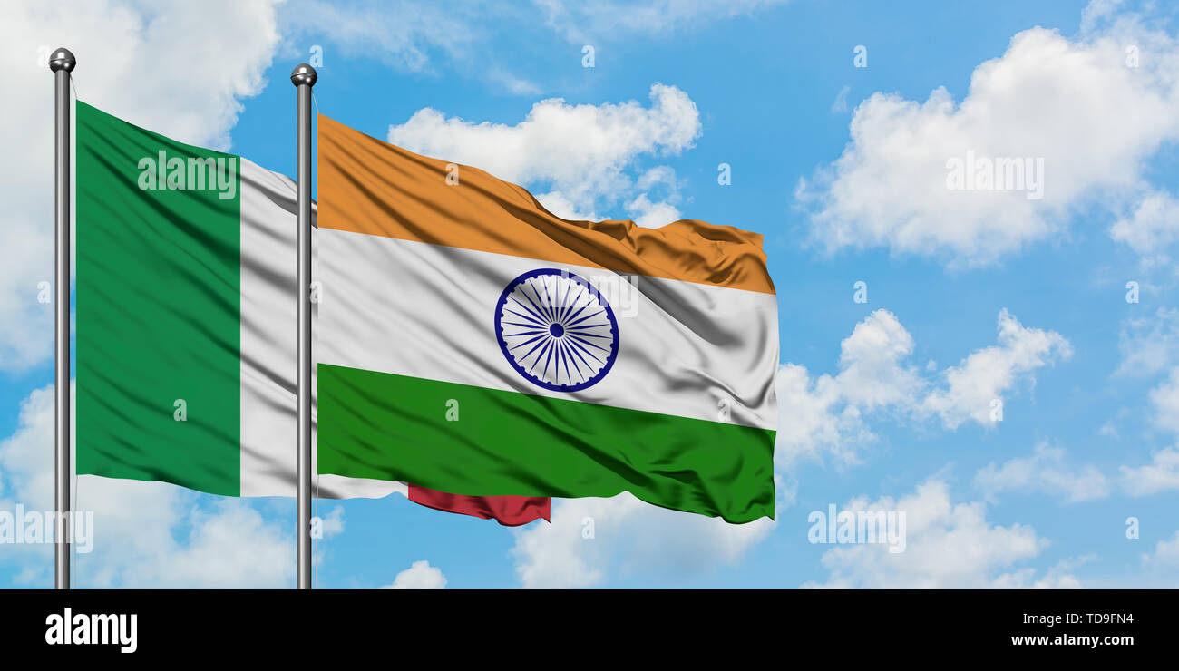 Italy and India flag waving in the wind against white cloudy blue sky ...