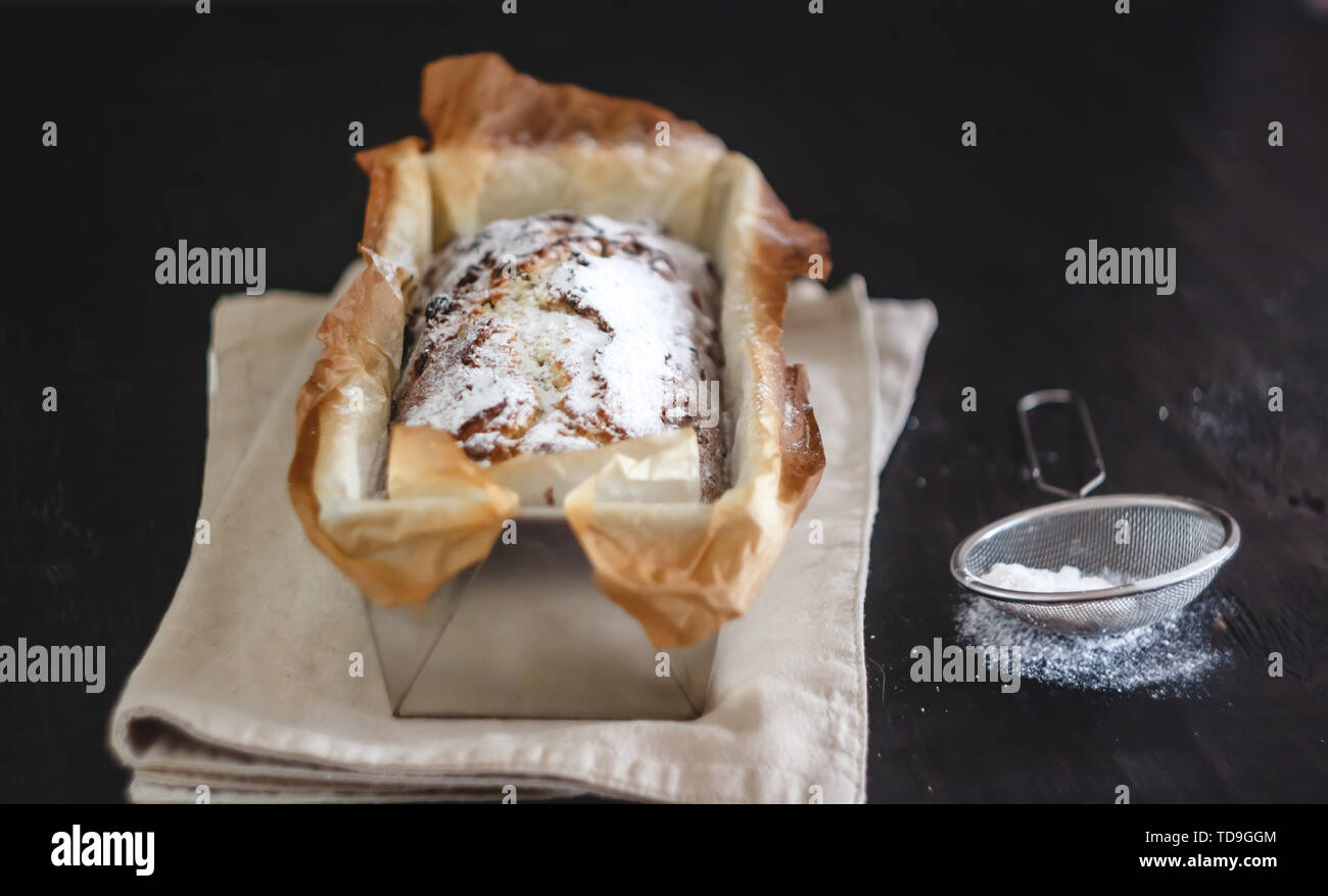 Rectangular capital cupcake with powdered sugar in a metal baking dish ...