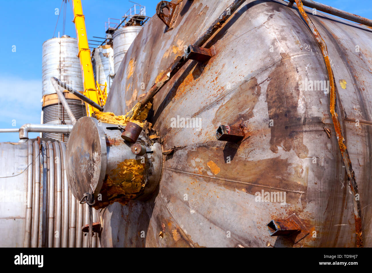 Obsolete massive old metal silos, tanks are lain down on the ground ...