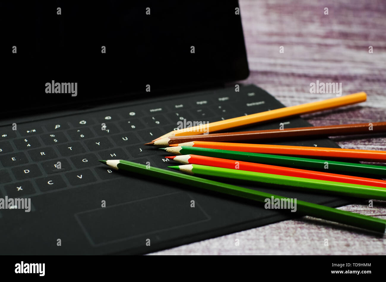 Colorful pencils and laptops Stock Photo - Alamy