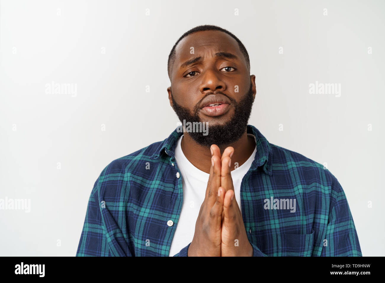 Handsome Afro American man keeping palms together like praying Stock ...