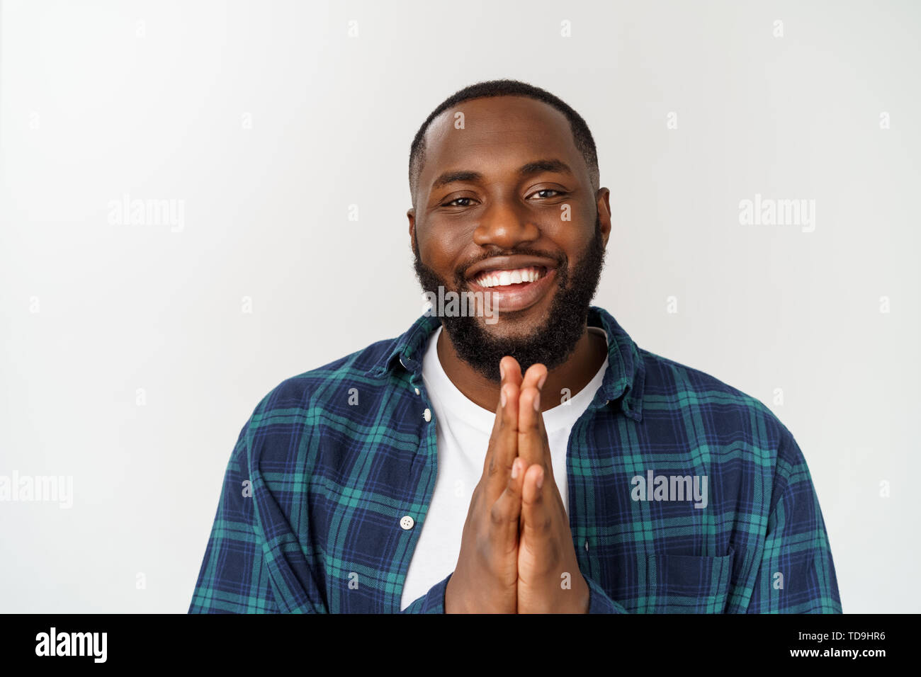 Handsome Afro American man keeping palms together like praying Stock ...