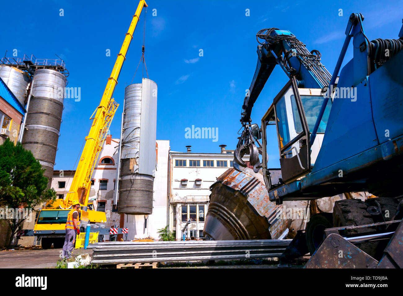Loader machine with hydraulic grappling claw and crane are bringing ...