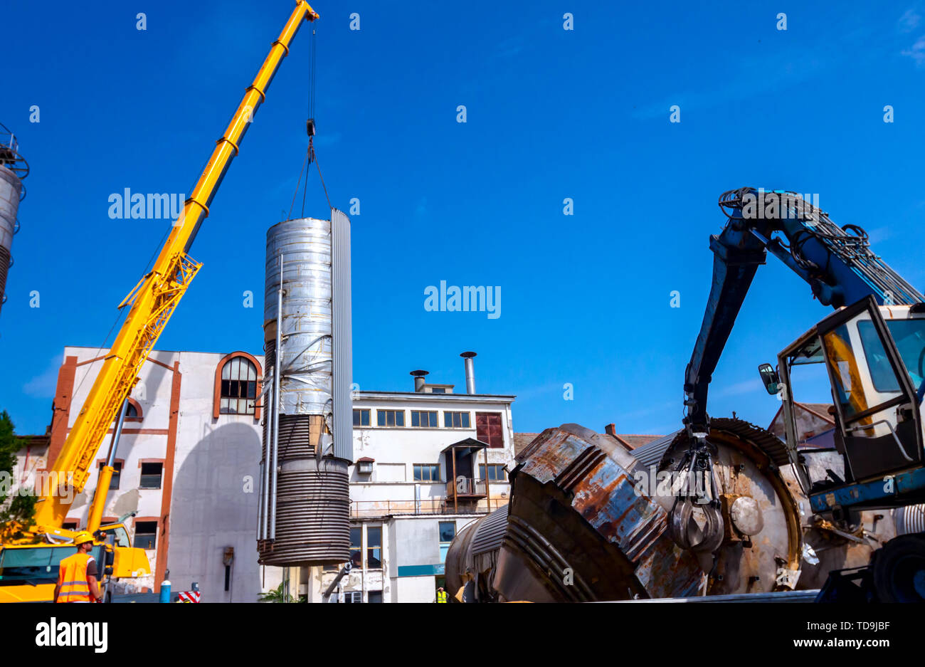 Loader machine with hydraulic grappling claw and crane are bringing ...