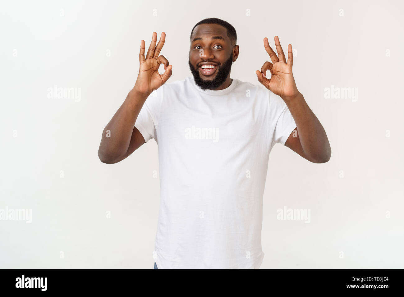 Portrait of happy african-american man showing ok sign and smiling ...