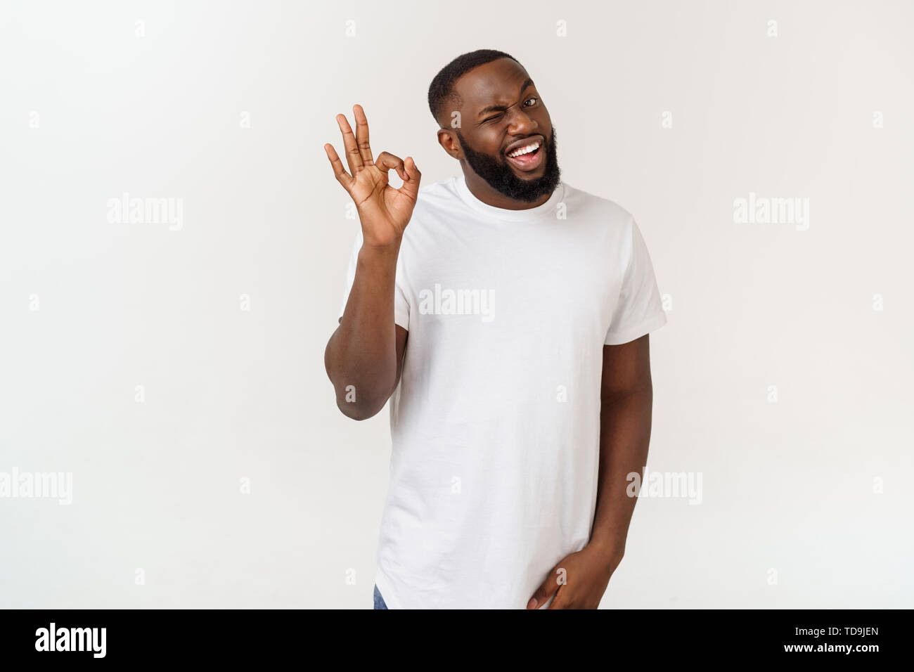 Portrait of happy african-american man showing ok sign and smiling ...