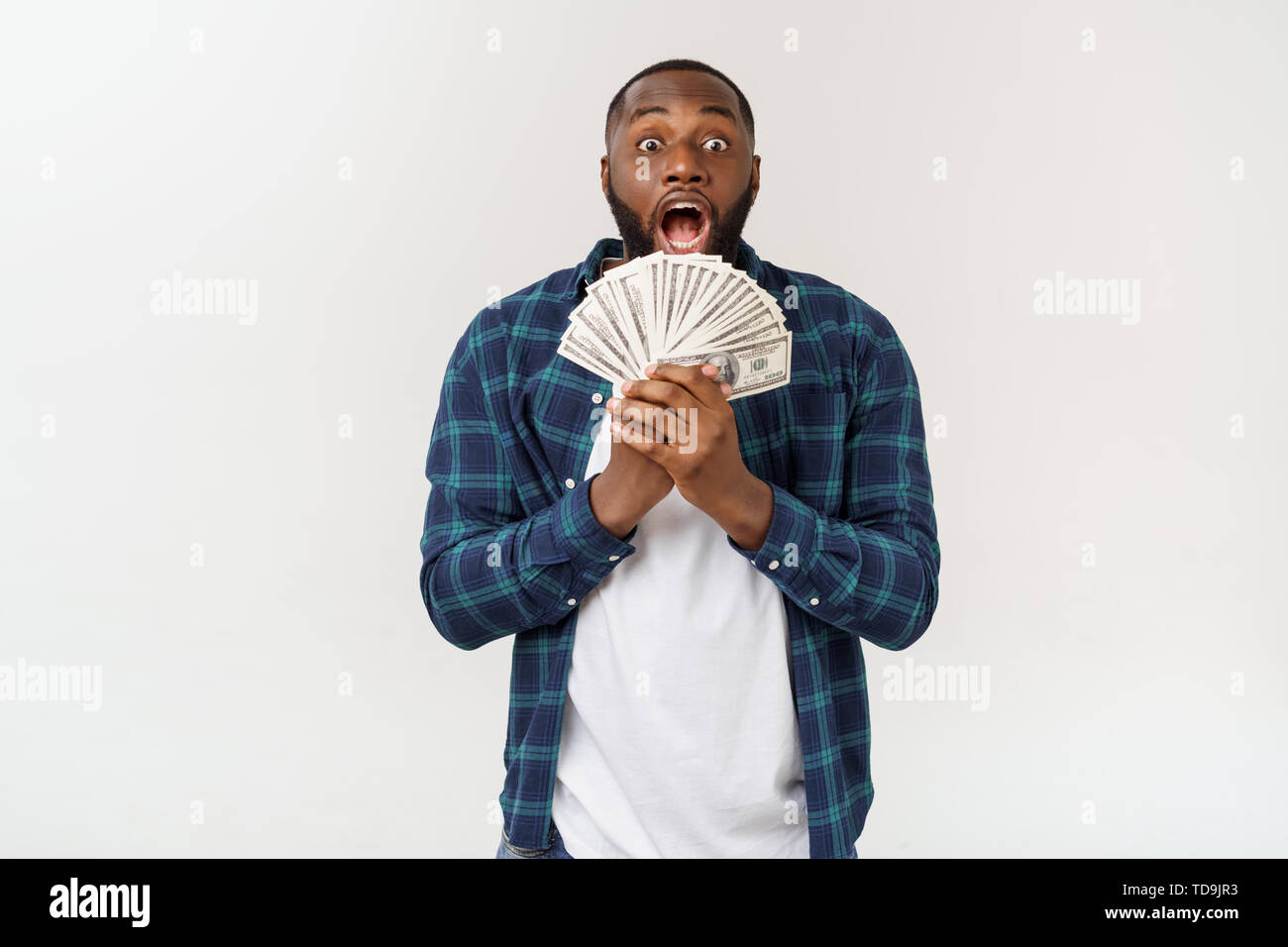 African man holding bank notes happy and surprised cheering expressing ...