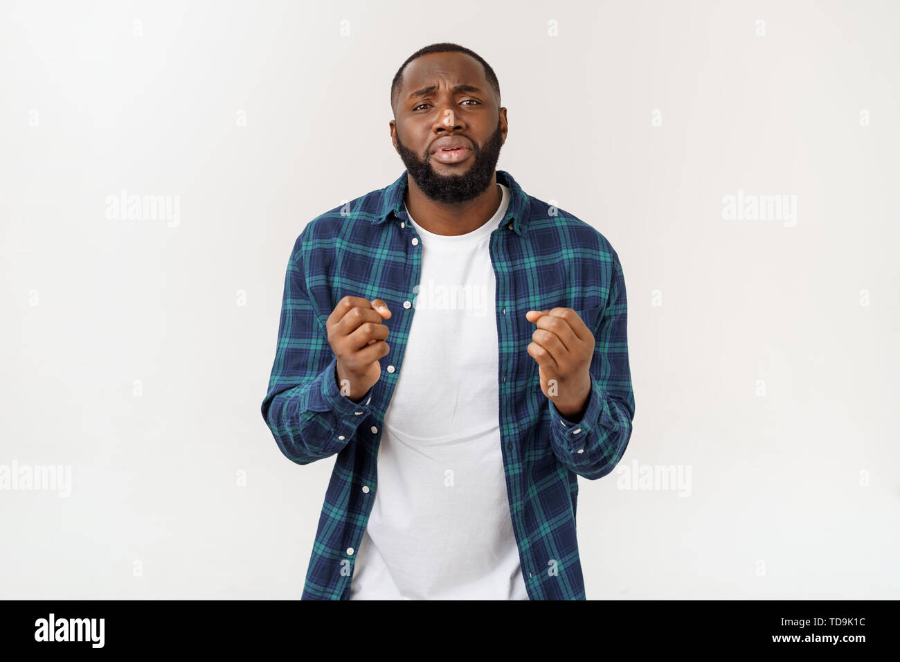 surprised young dark-skinned African American man student staring at camera with shocked look ...