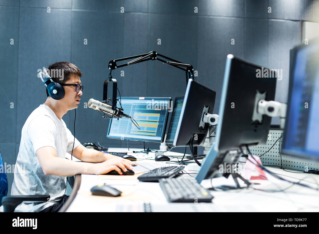 young man dj works in modern broadcast studio Stock Photo - Alamy