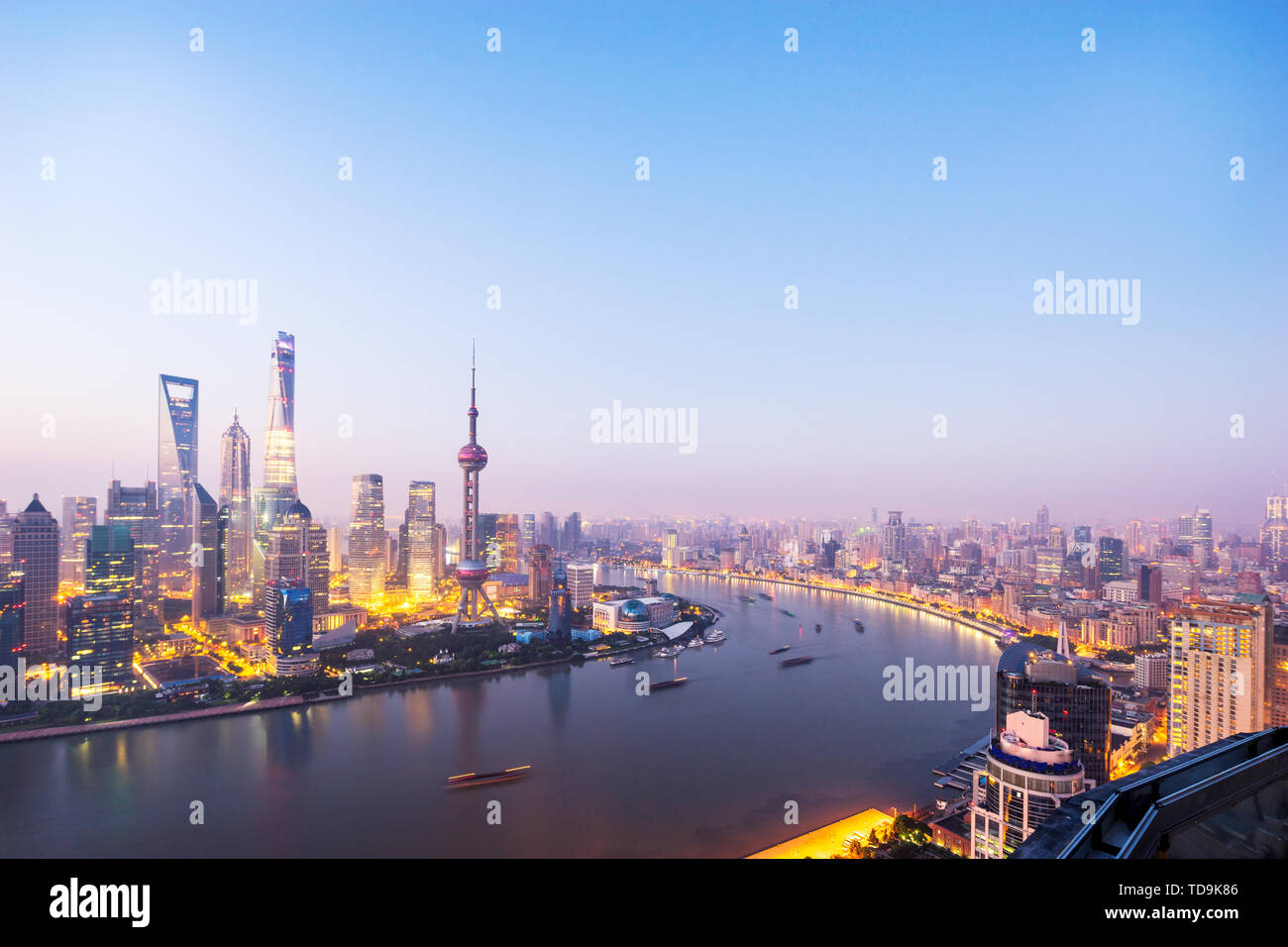 waterfront cityscape and illuminated skyline at dawn Stock Photo - Alamy