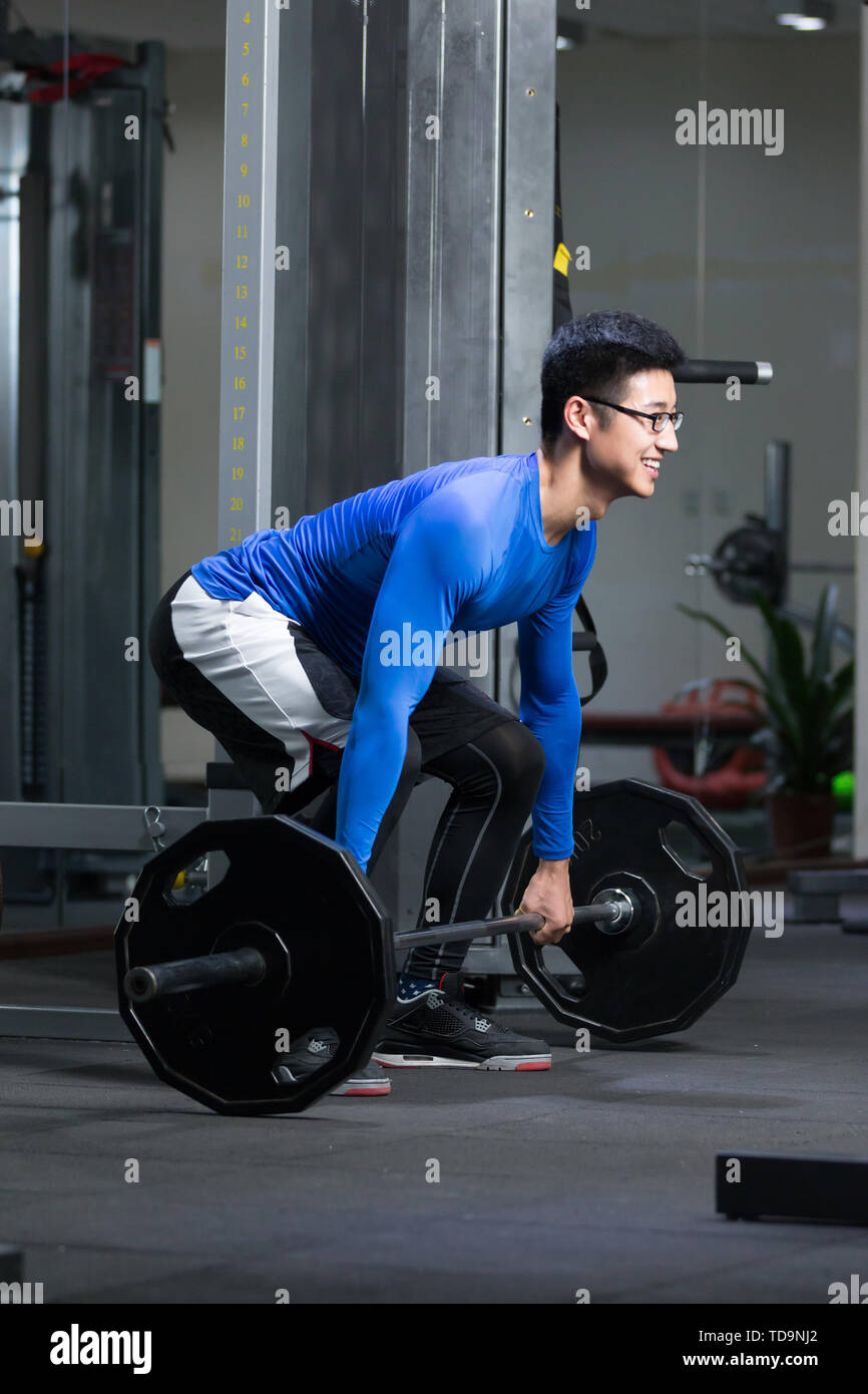 young asian man working out in modern gym Stock Photo - Alamy