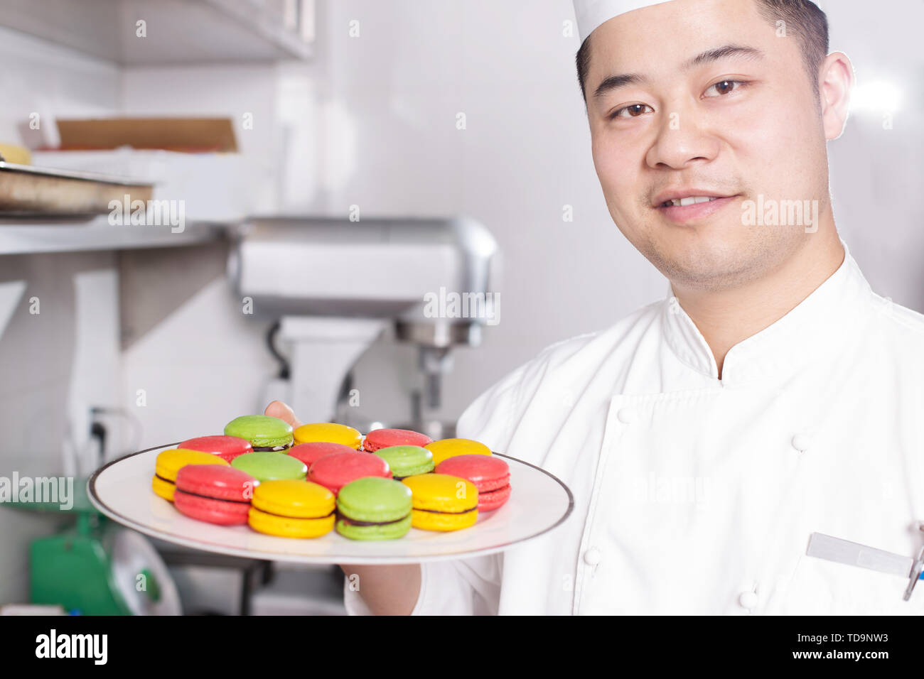 young chinese man chelf making food in modern kitchen Stock Photo - Alamy