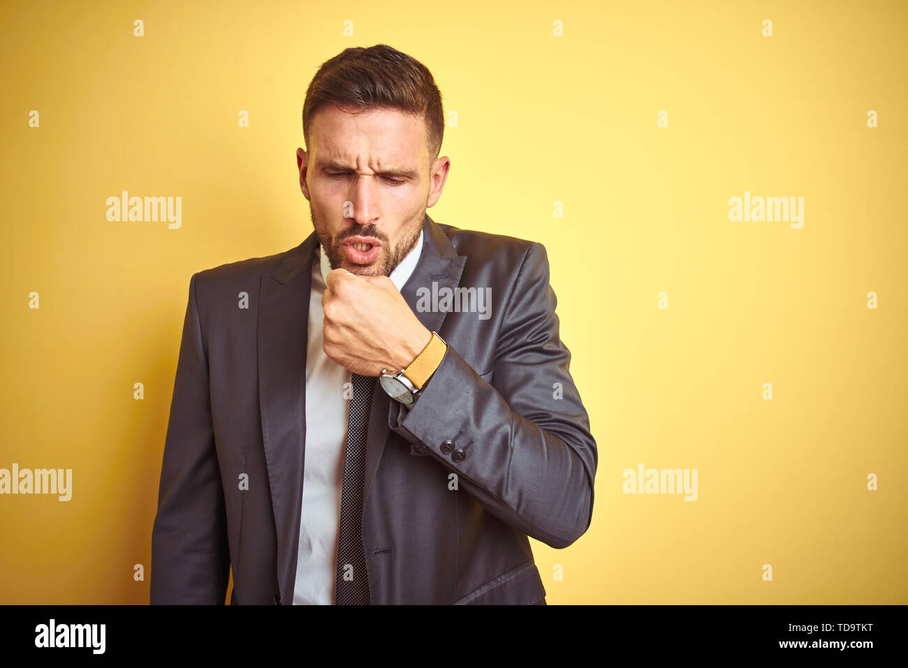 Young handsome business man over yellow isolated background feeling ...