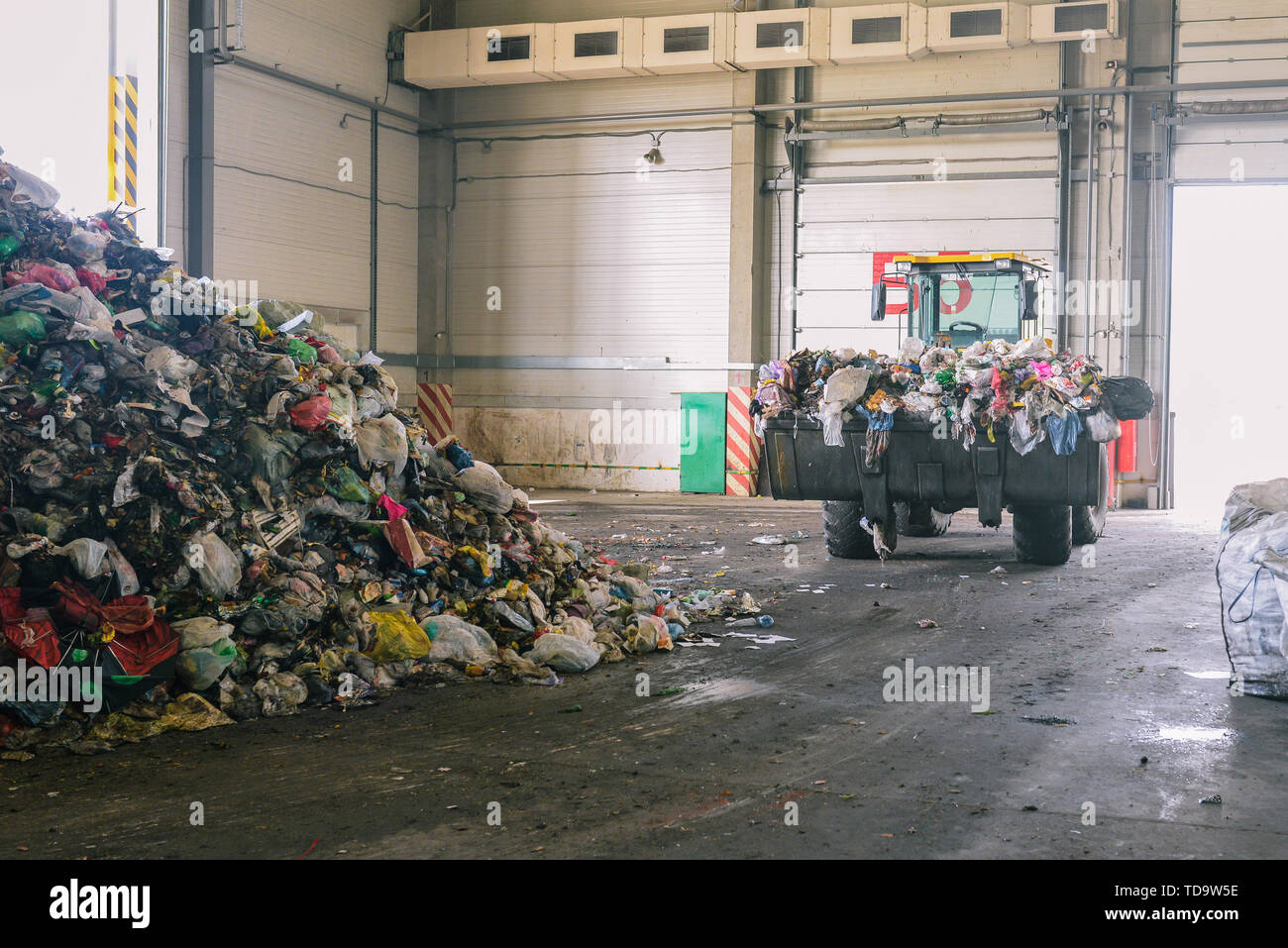 Tractor transports garbage at the plant for processing and sorting ...