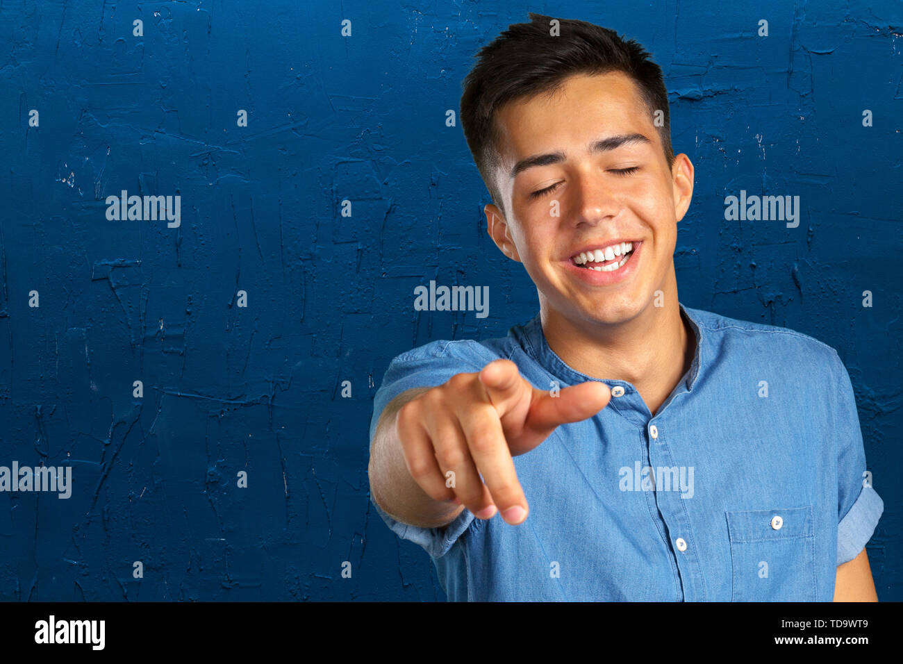 Portrait of a young man pointing his finger at you Stock Photo - Alamy
