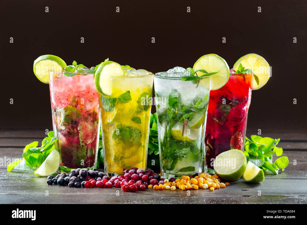 Different types of mojito cocktail on dark brown background Stock Photo ...