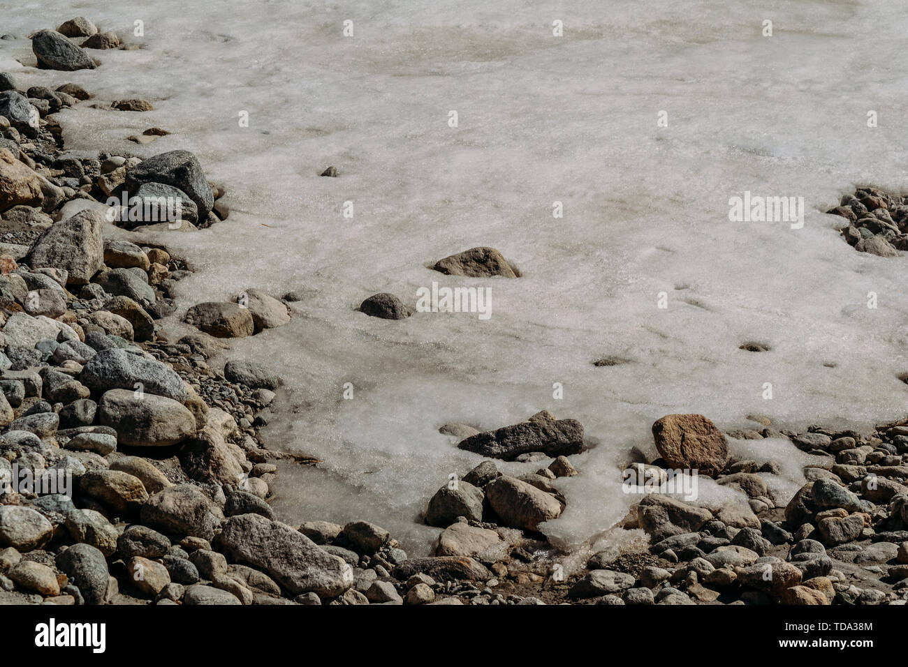 stones and snow in the highlands in the daytime Stock Photo - Alamy