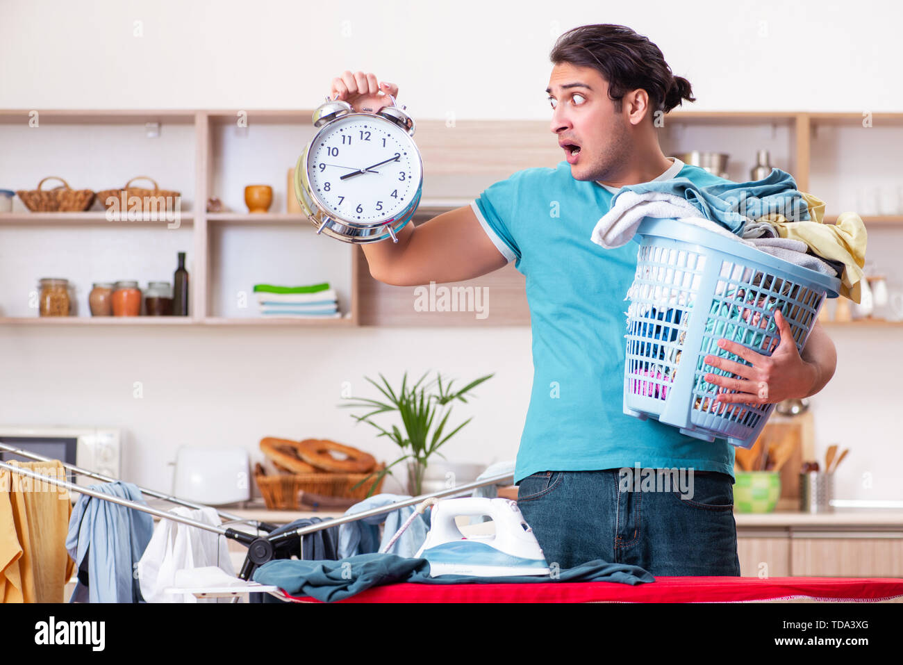 Young man husband doing clothing ironing at home Stock Photo - Alamy