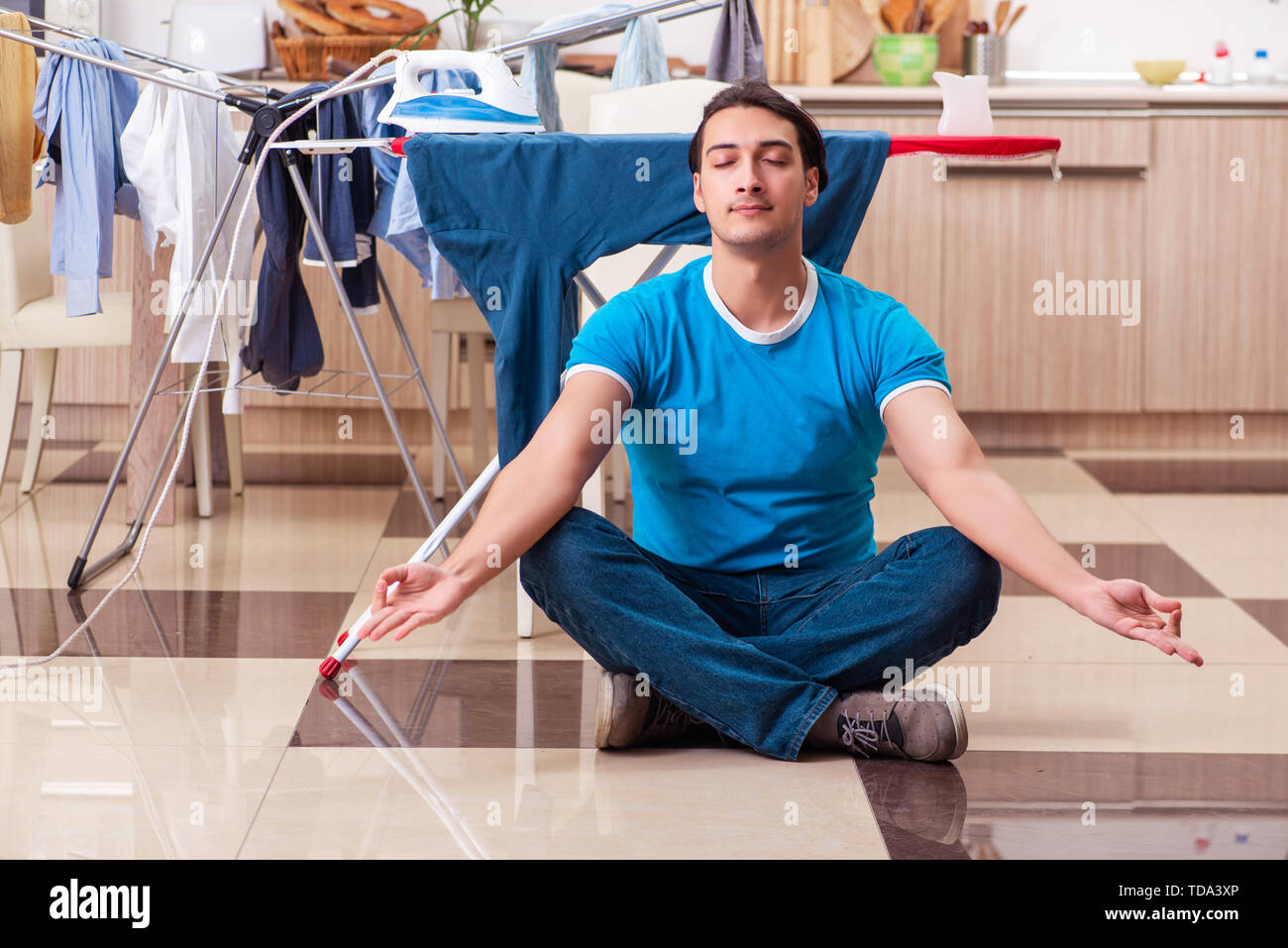 Young man husband doing clothing ironing at home Stock Photo - Alamy