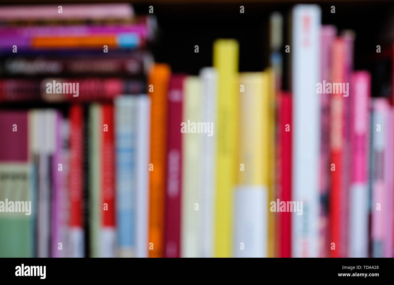 Abstract blurred bookshelf with colorful bright books. Education and ...