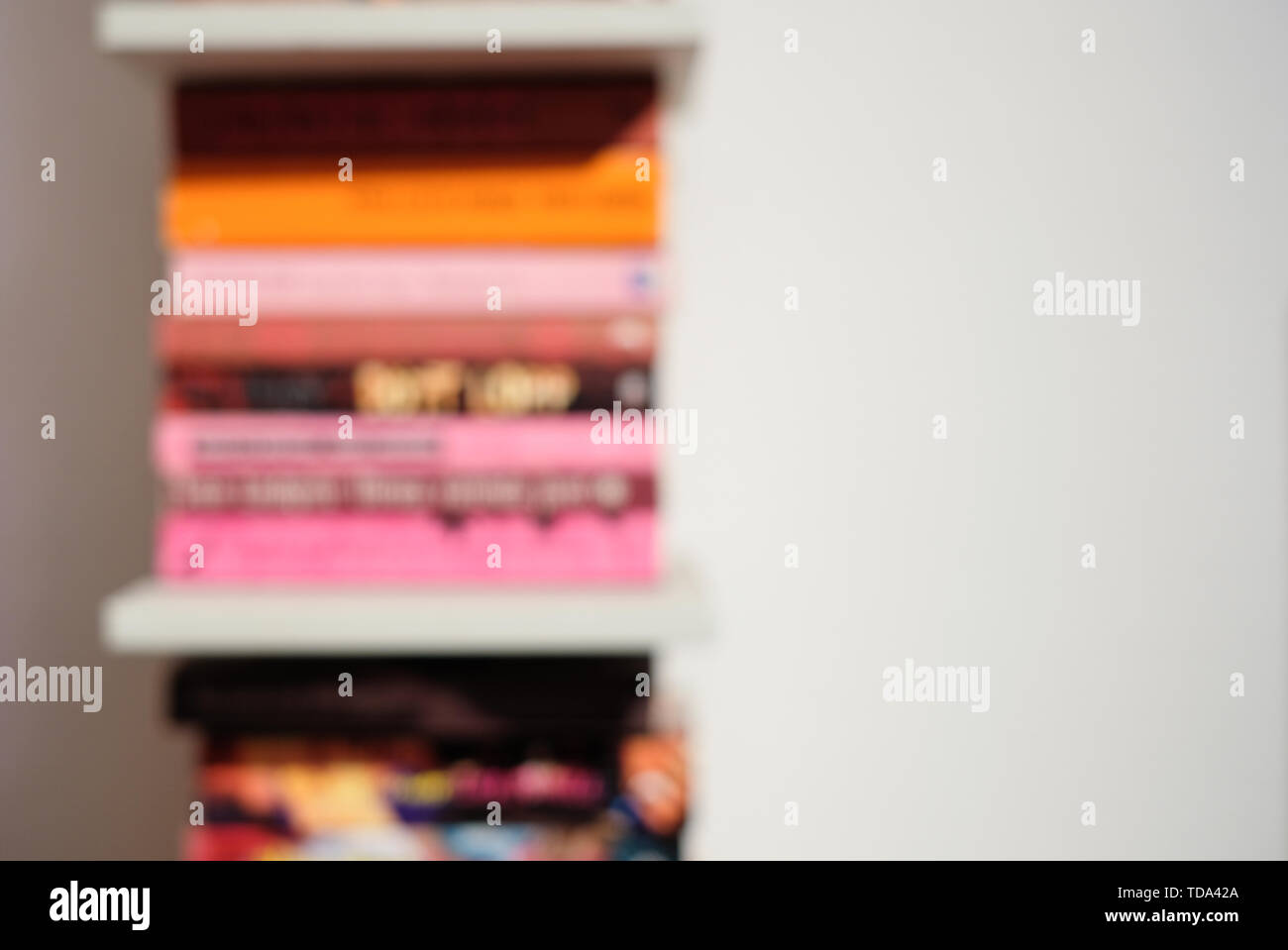 Abstract blurred bookshelf with colorful bright books. Education and ...