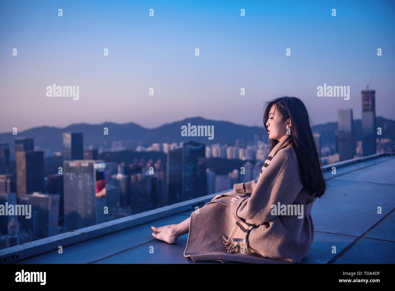 Girl on the rooftop Stock Photo - Alamy