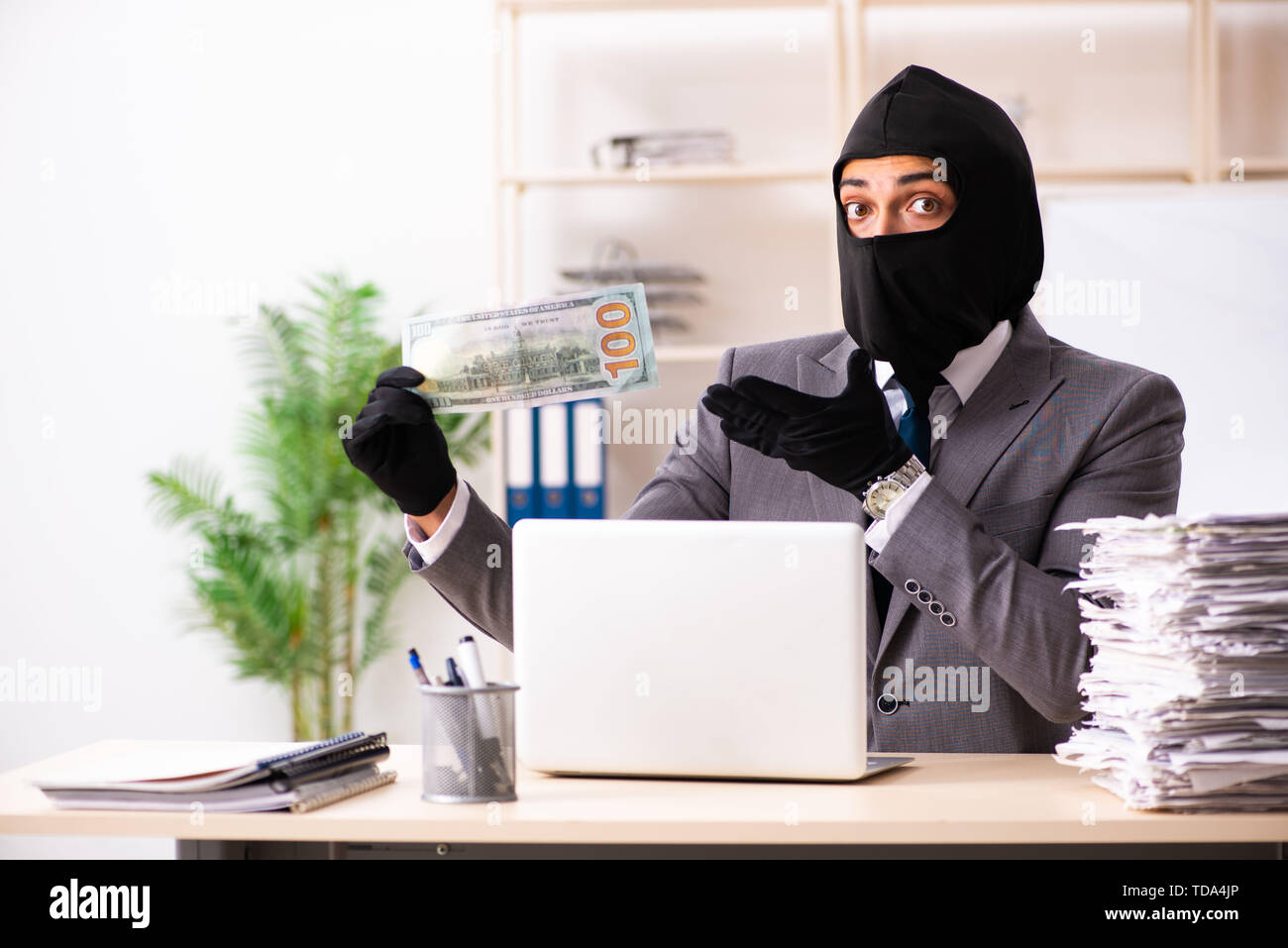 Male gangster stealing information from the office Stock Photo - Alamy