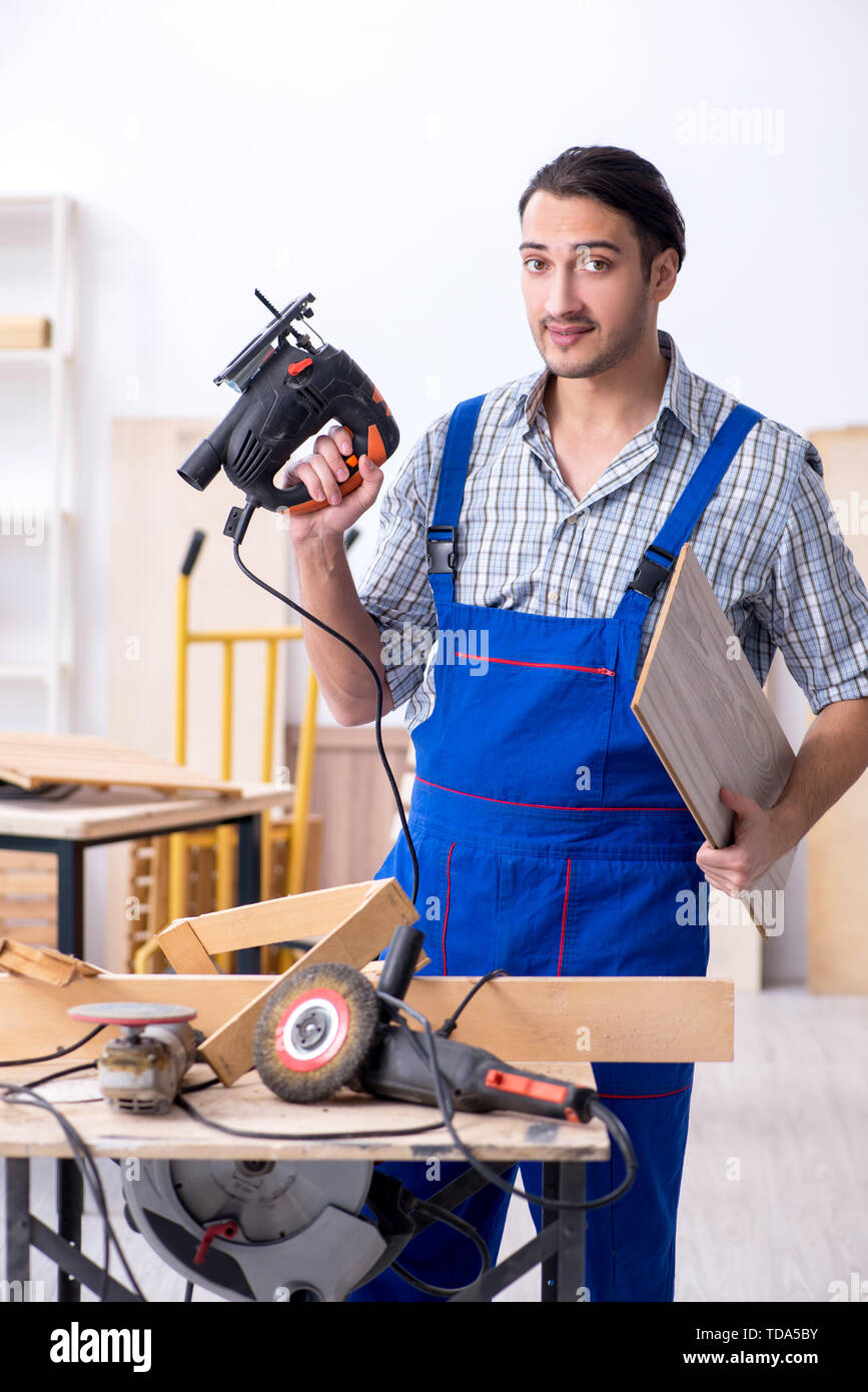 Young male carpenter working indoors Stock Photo - Alamy