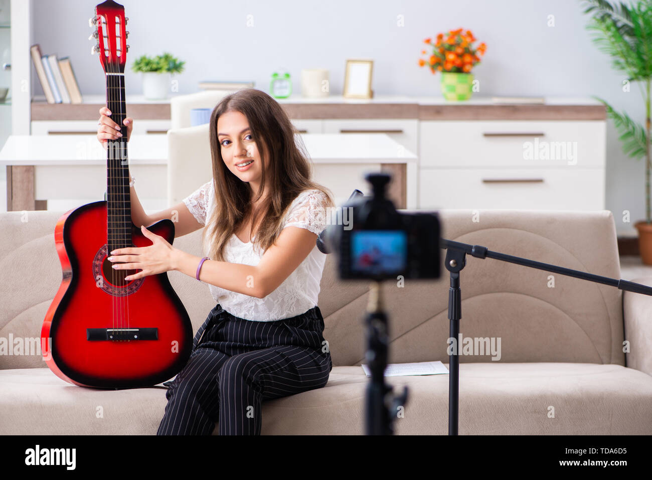 Female beautiful blogger playing guitar Stock Photo - Alamy
