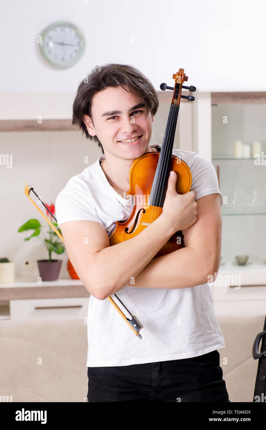 Young musician man practicing playing violin at home Stock Photo - Alamy
