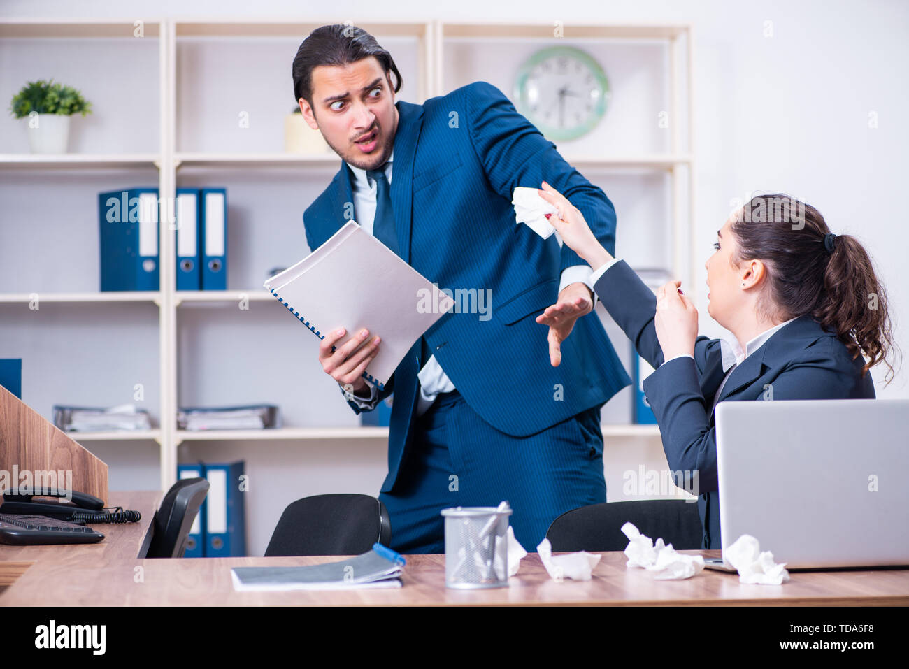Two employees suffering at workplace Stock Photo - Alamy