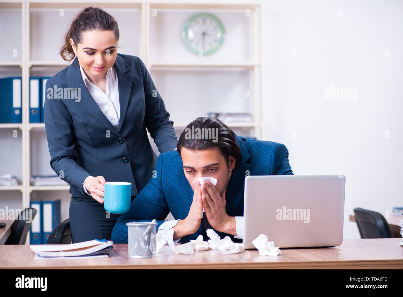 Two employees suffering at workplace Stock Photo - Alamy