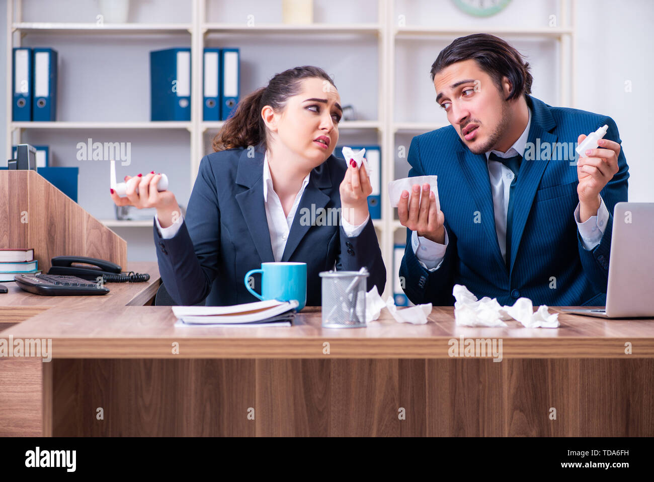 Two employees suffering at workplace Stock Photo - Alamy