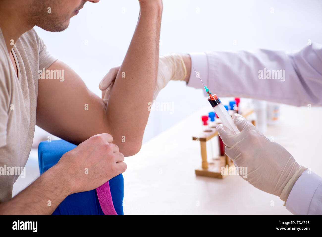 Young handsome man during blood test sampling procedure Stock Photo - Alamy