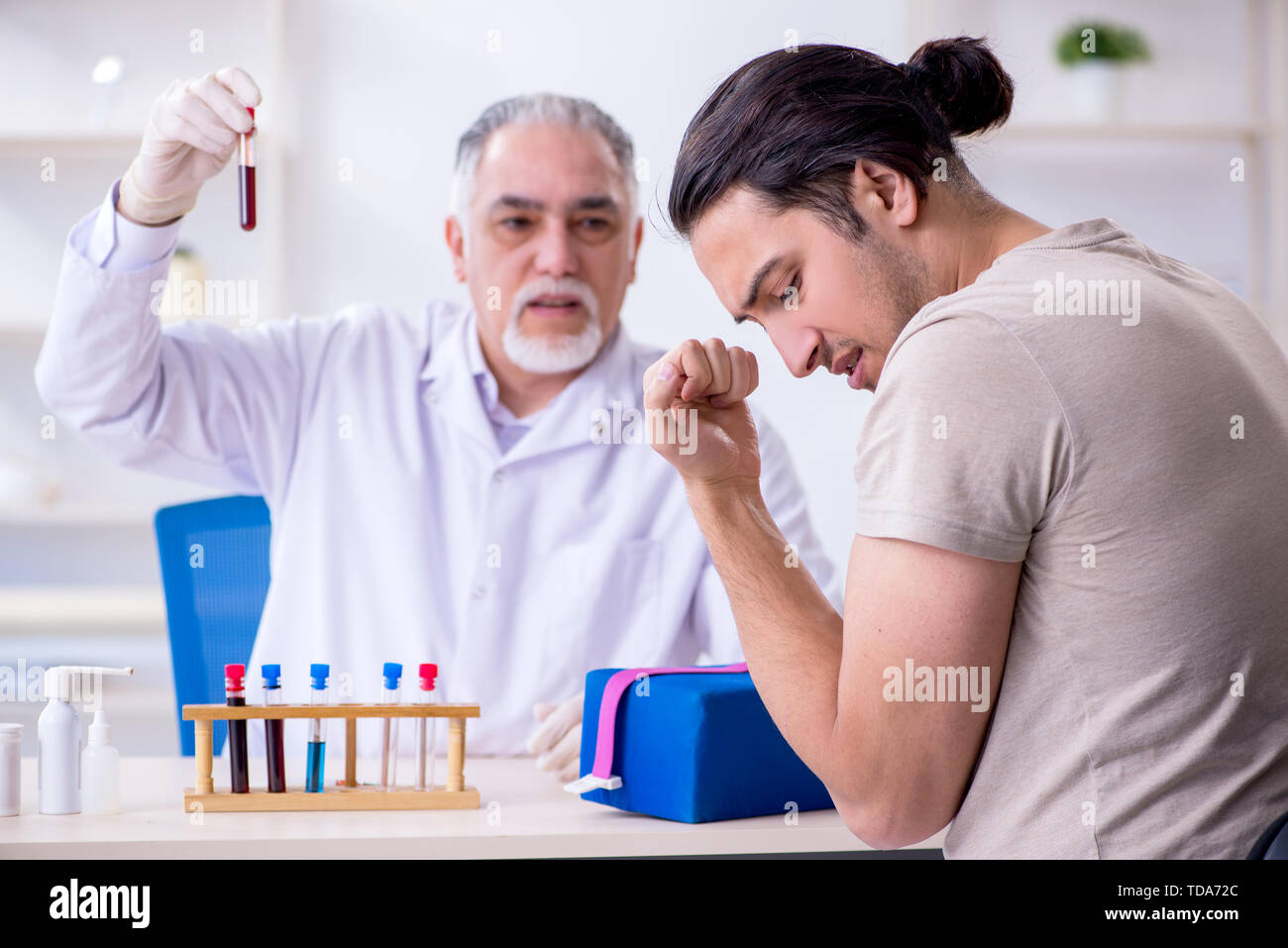 Young handsome man during blood test sampling procedure Stock Photo - Alamy