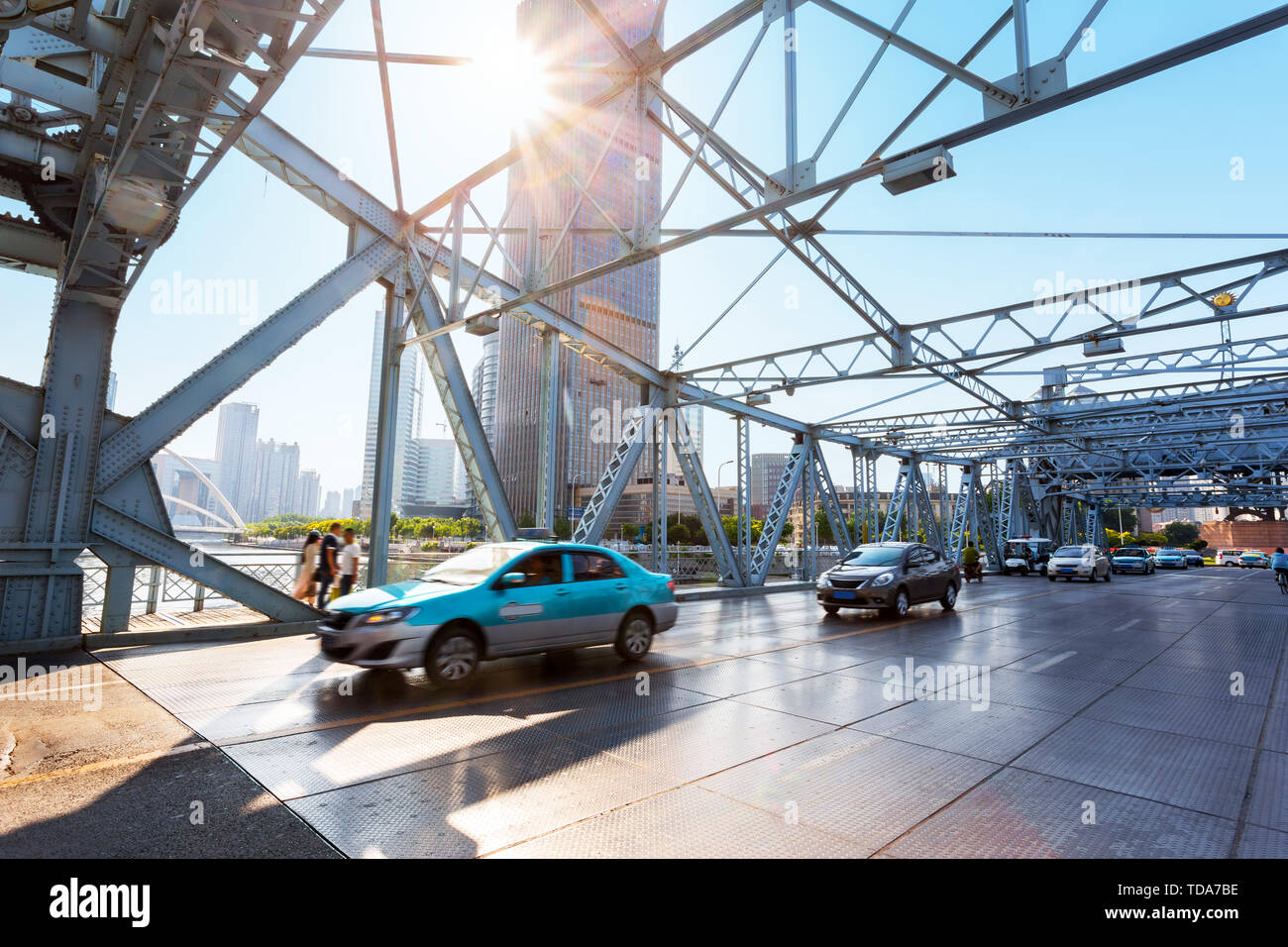 Traffic on steel bridge interior and skyline at sunset Stock Photo - Alamy