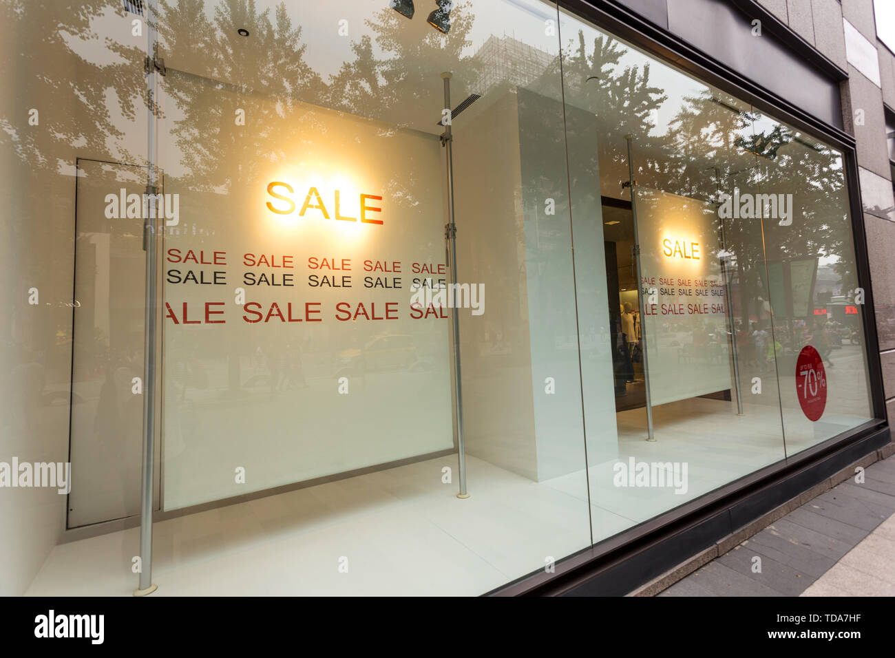 sale poster in the displaywindow of shop Stock Photo - Alamy